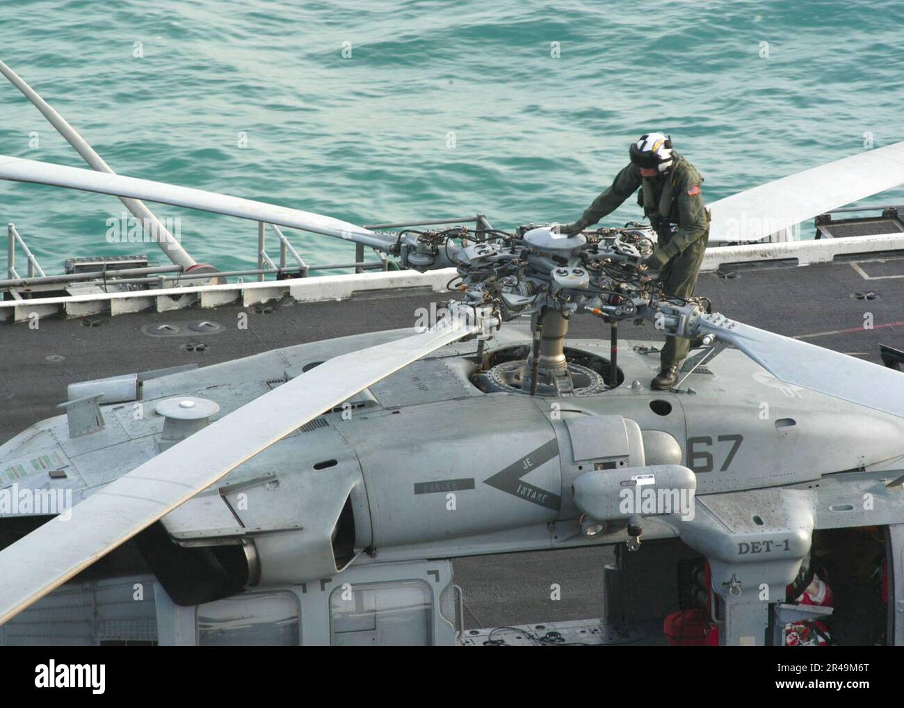 US Navy A pilot checks the rotor assembly on an HH-60H Seahawk assigned ...