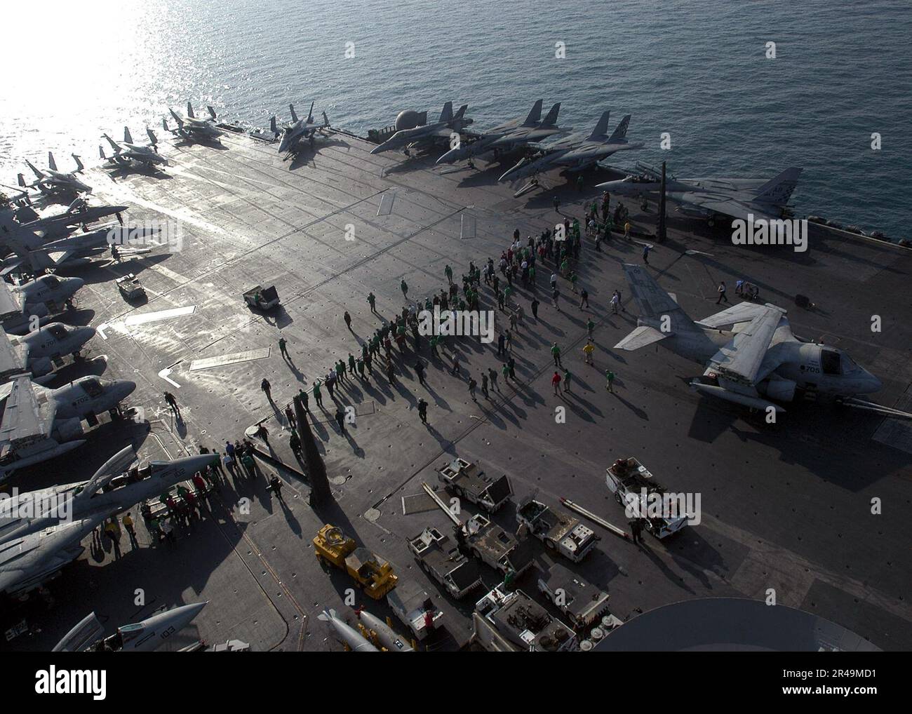 US Navy Sailors carefully scour the flight deck aboard USS Enterprise ...
