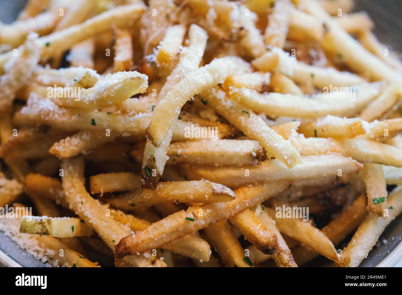 A platter of salted French fries in a closeup view, ready to be served ...