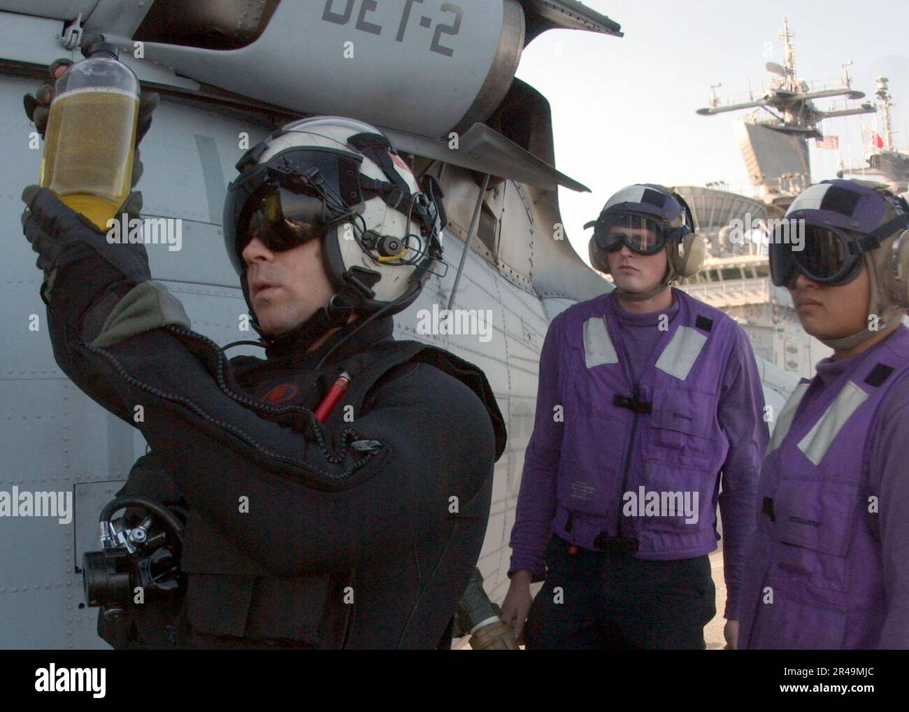 US Navy An air crewman checks a JP-5 aviation fuel sample for an HH-60H ...