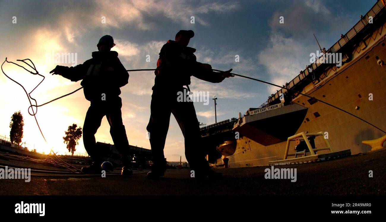 US Navy Line handlers receive mooring lines from USS Carl Vinson (CVN ...