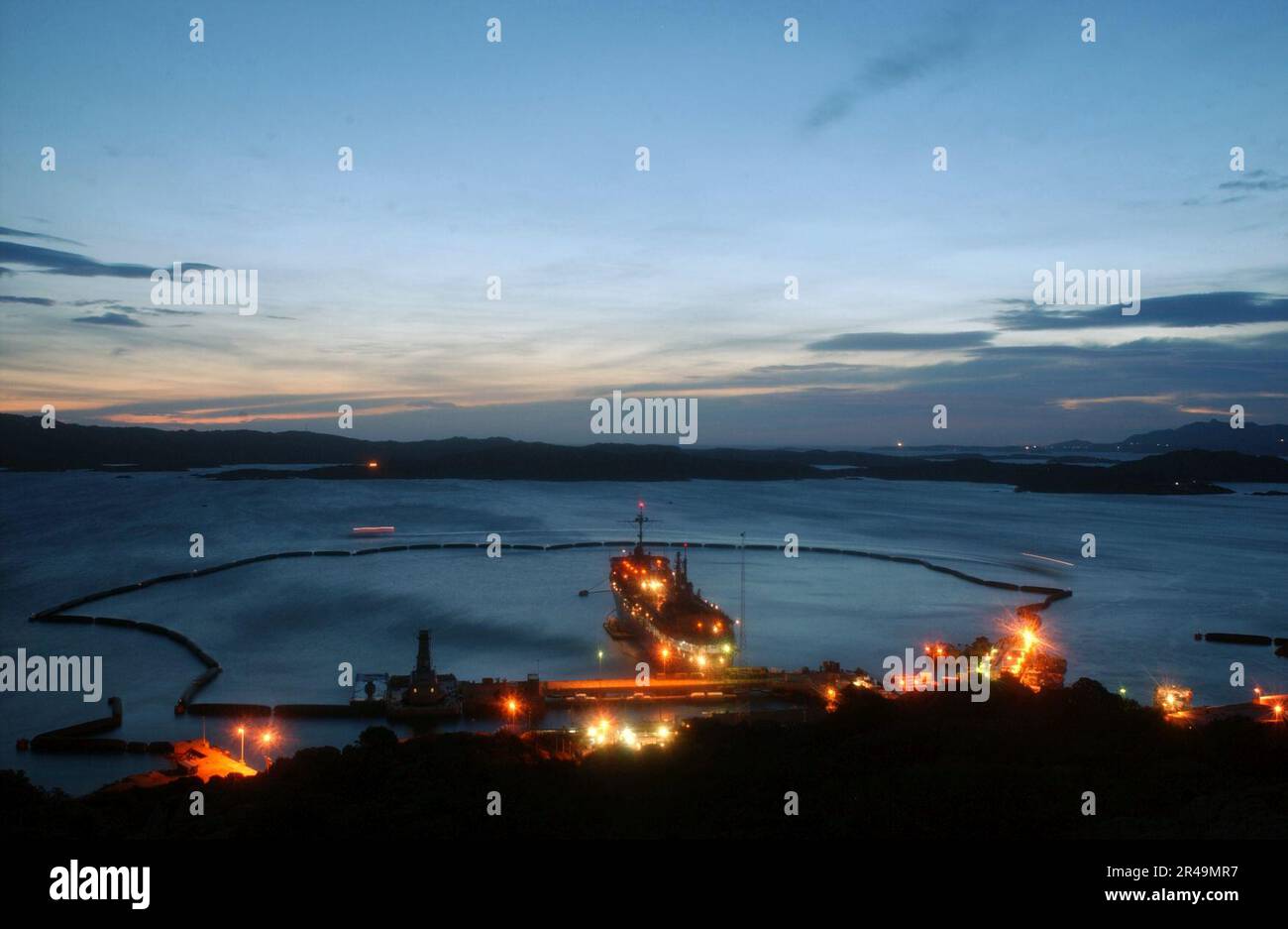 US Navy The sun rises behind the submarine tender USS Emory S. Land (AS ...