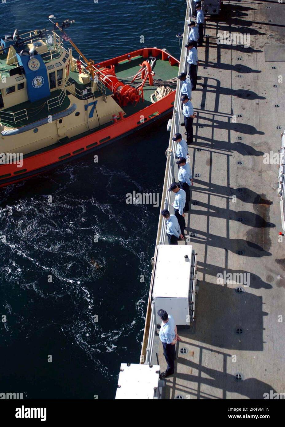 US Navy Sailors assigned to USS Boxer (LHD 4) man the rails as the ship ...