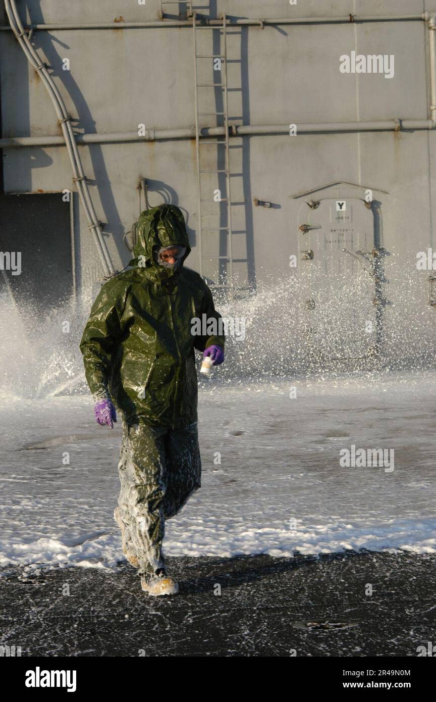 US Navy A Sailor assigned to USS Kitty Hawk (CV 63) brings a sample of ...