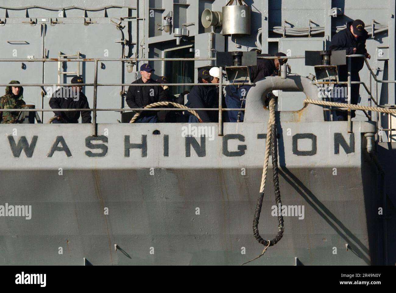 US Navy Sea Anchor Detail work to haul in the aft mooring lines before ...