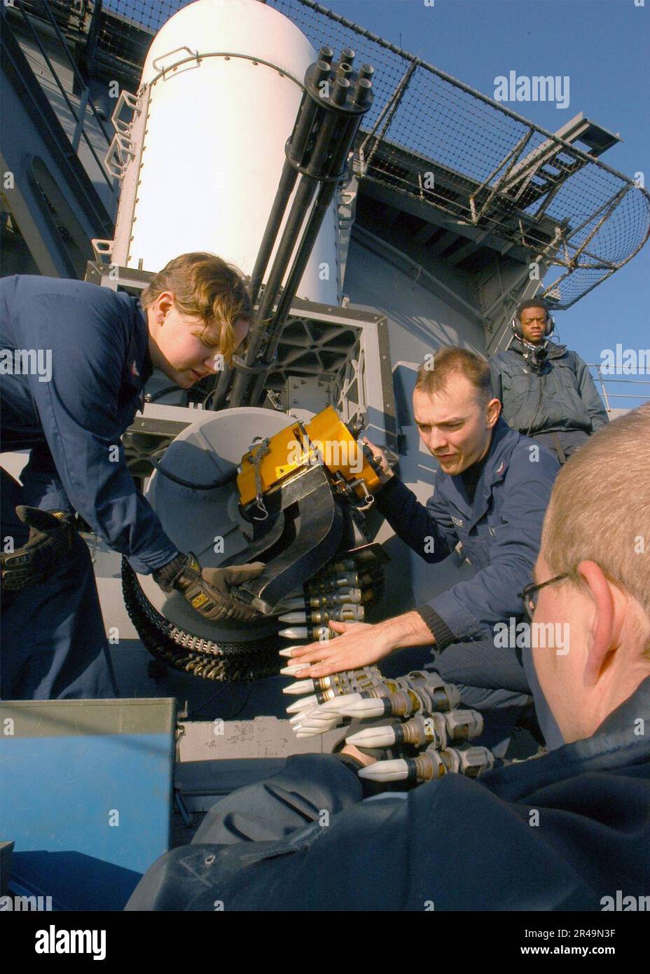 US Navy Fire Controlmen load ammunition into a Close-In Weapons System ...