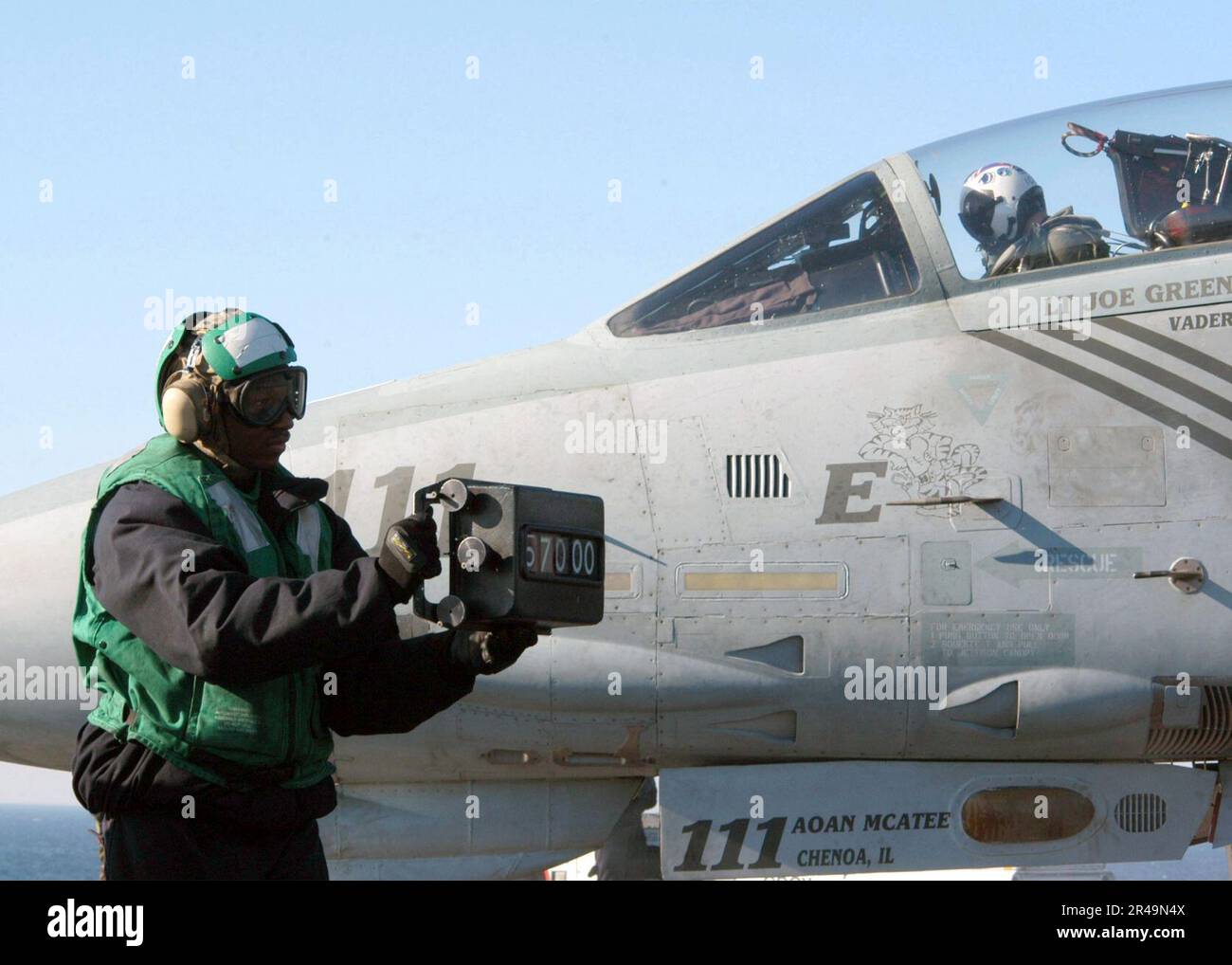 US Navy shows the weight board to the catapult operator as an F-14B ...