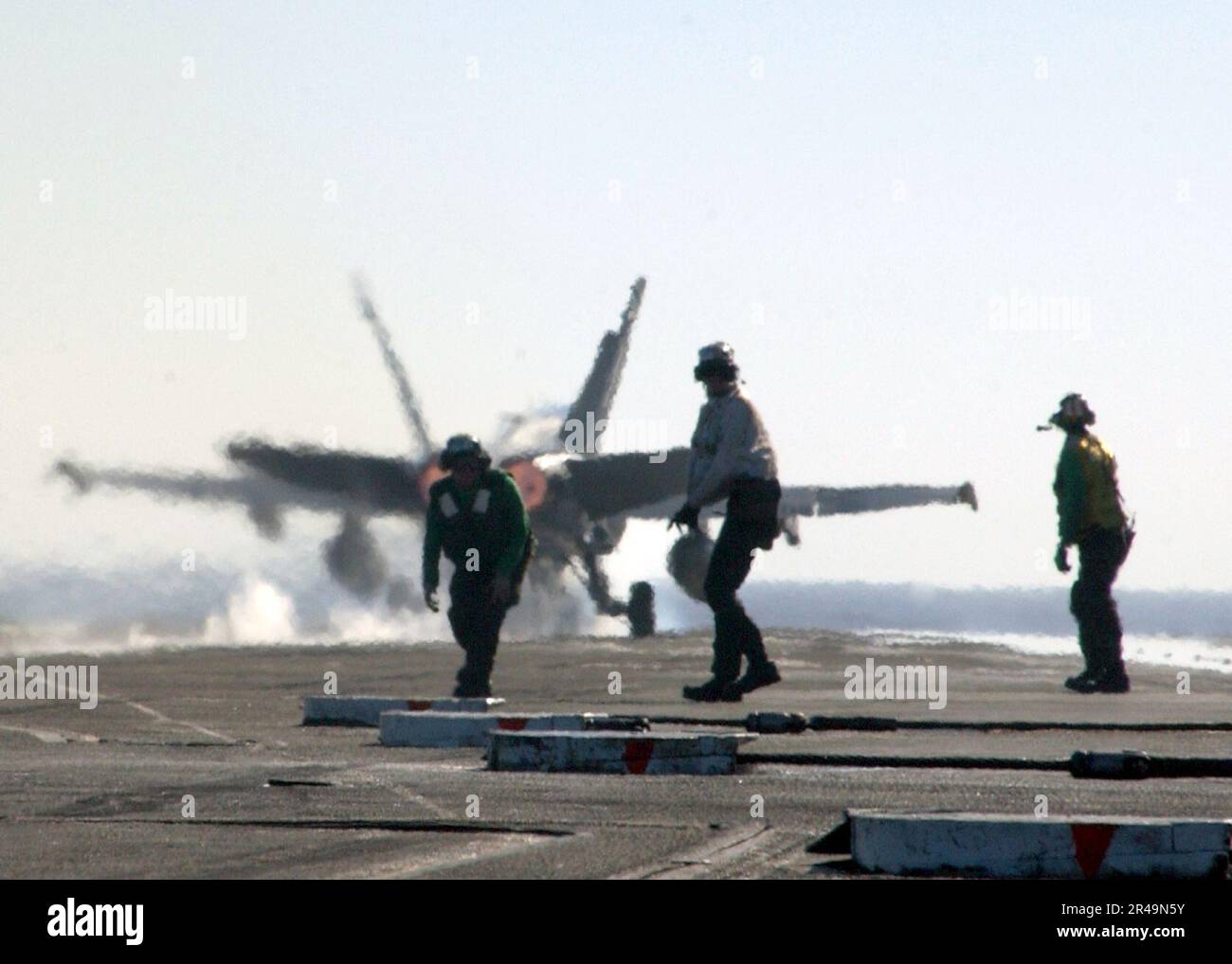 US Navy Flight deck personal aboard USS Carl Vinson (CVN 70) avoid the ...