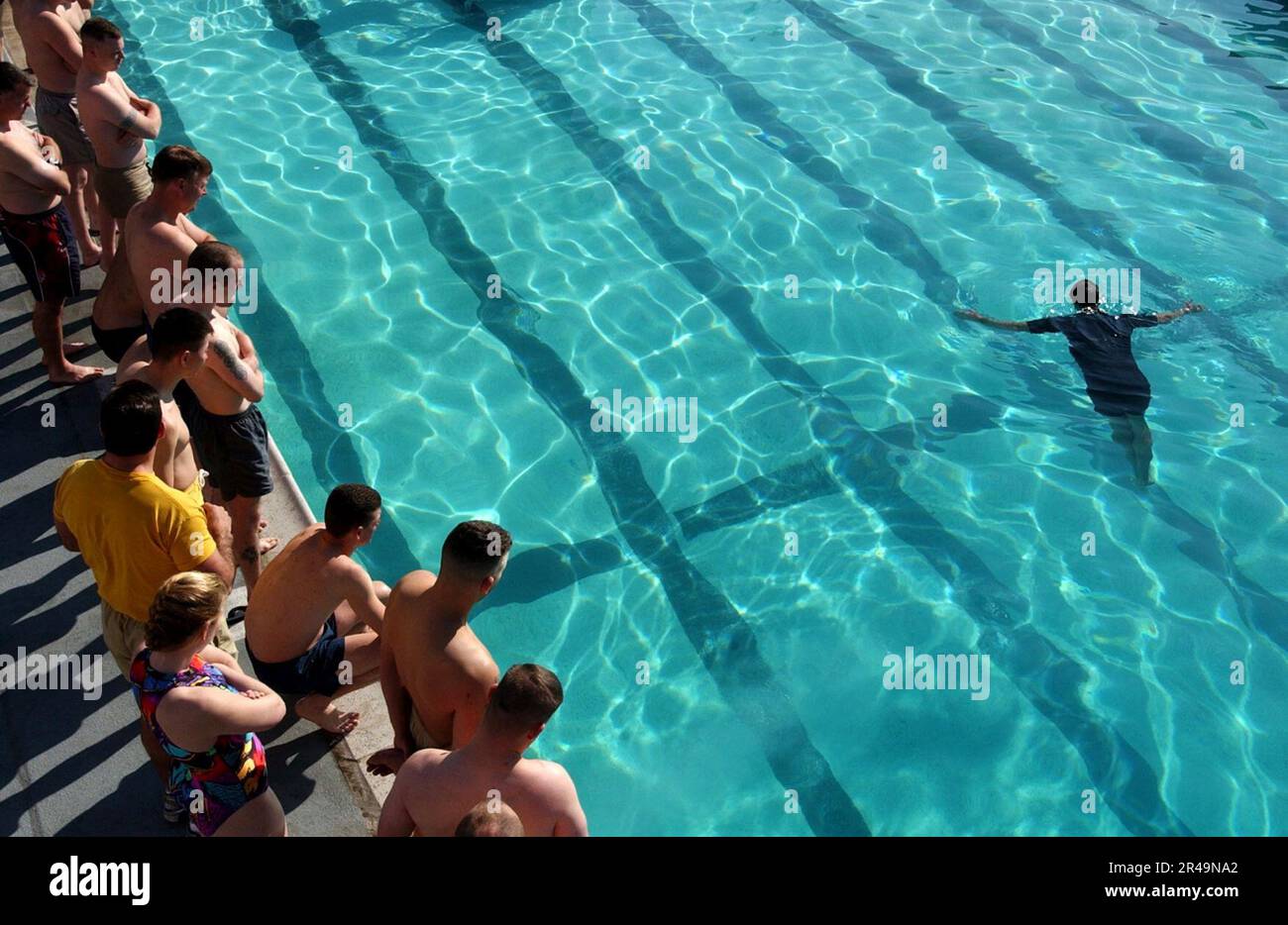 US Navy Aviation Survival students watch as an instructor demonstrates ...