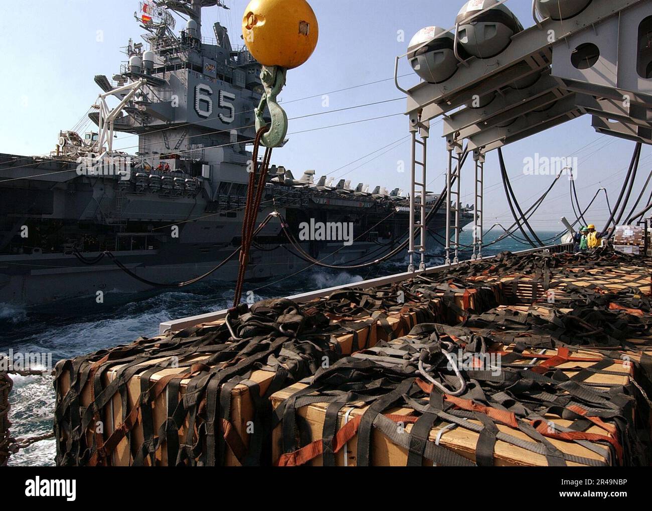 US Navy Equipment and supplies sit staged aboard the fast combat ...