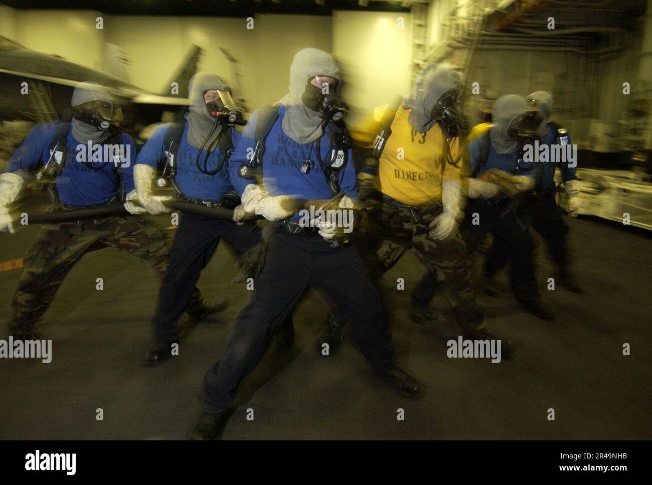 US Navy Members of the ship's hangar bay firefighting and damage ...