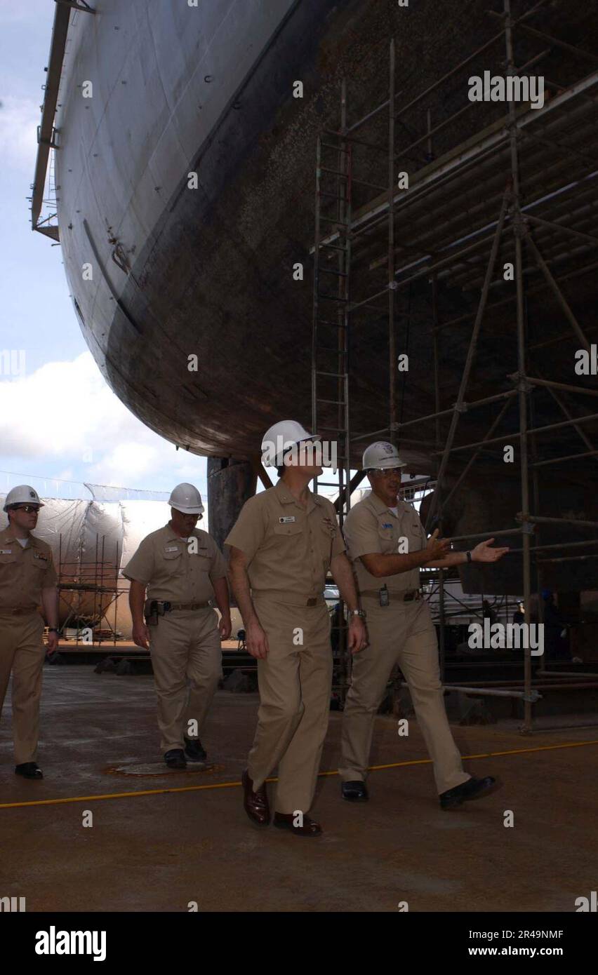 US Navy Commander, Submarine Group Seven, Rear Adm. John Donnelly, center, and USS Frank Cable ...