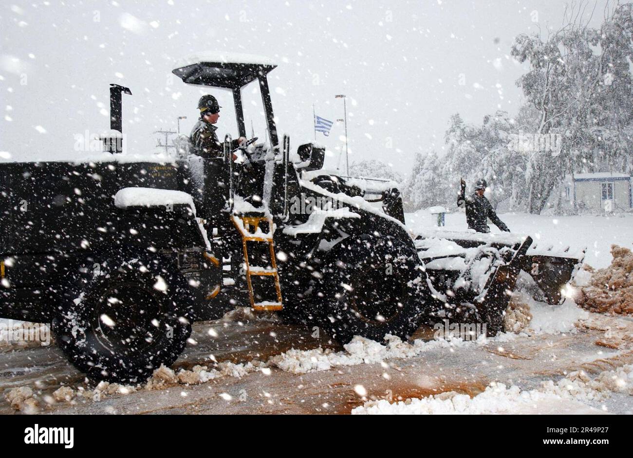 US Navy Equipment Operator Constructionman operates a front-end loader ...