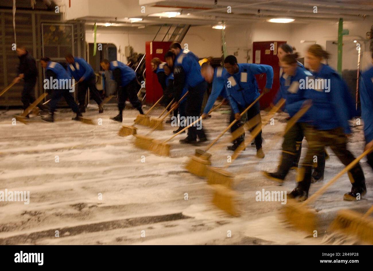 US Navy Sailors scrub down the ship's hangar bay aboard the nuclear ...