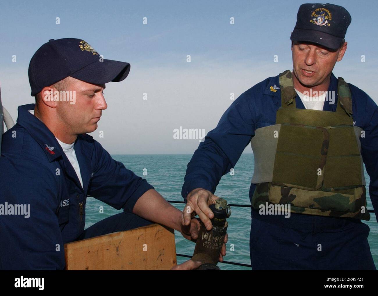 US Navy Gunner's Mate 1st Class right, conducts anti-swimmer concussion ...