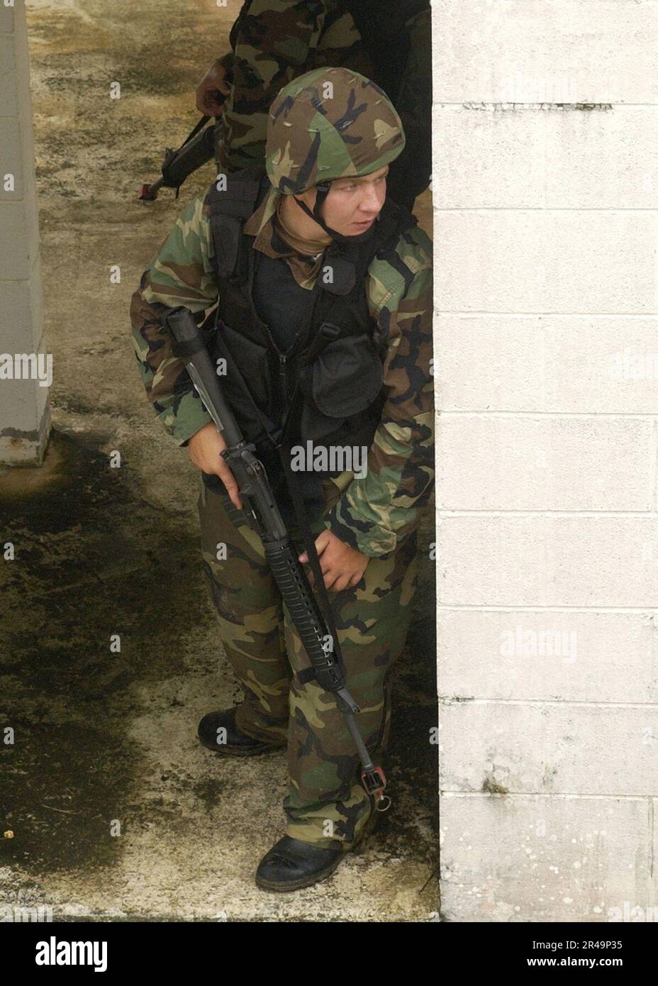 US Navy A member of Mobile Security Squadron Seven cautiously looks ...