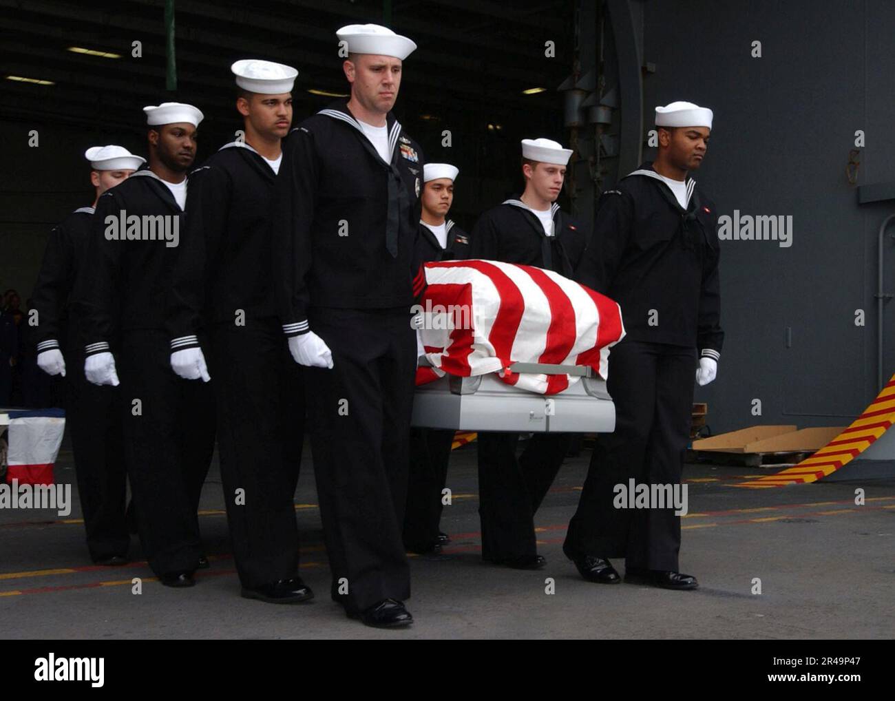 US Navy Pallbearers carry the casket for a retired U.S. Navy Commander ...