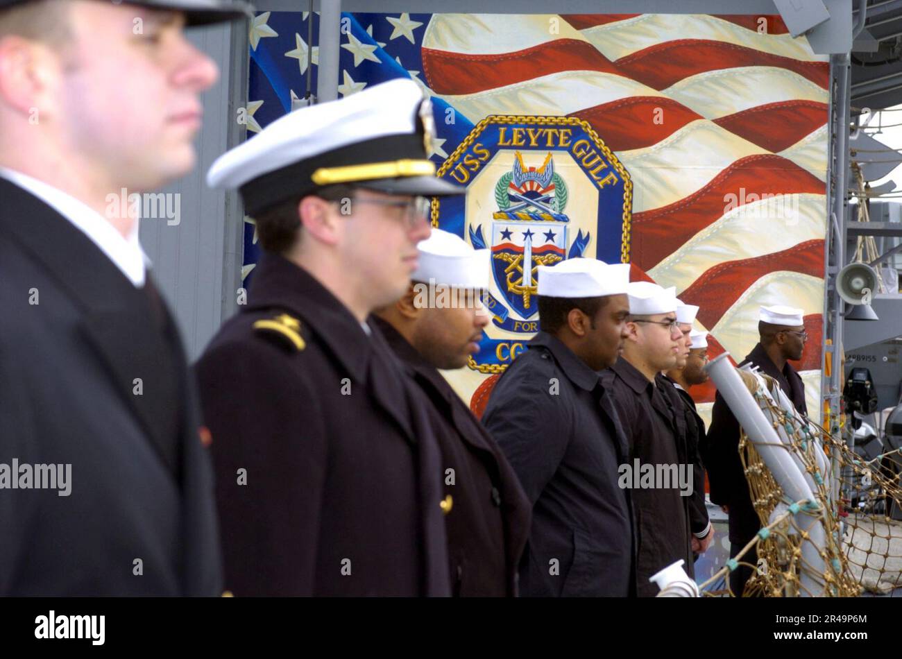US Navy Officers and Sailors assigned to the guided missile cruiser USS ...