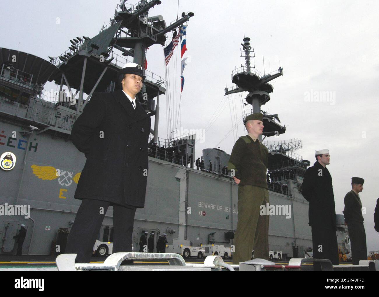 US Navy Sailors and Marines man the rails aboard the amphibious assault ...