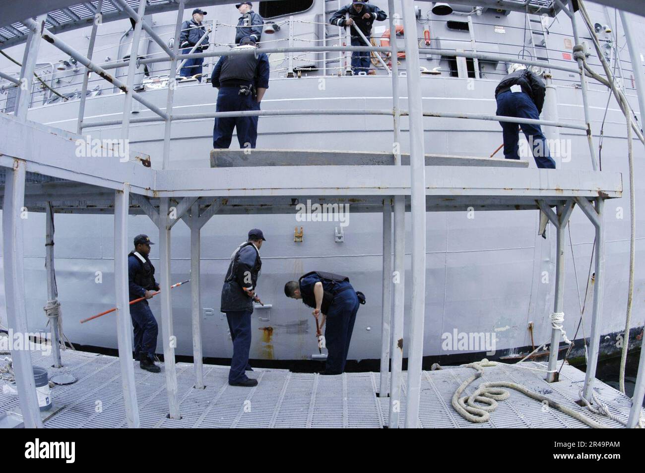 US Navy Deck department personnel complete re-painting the ship from a ...