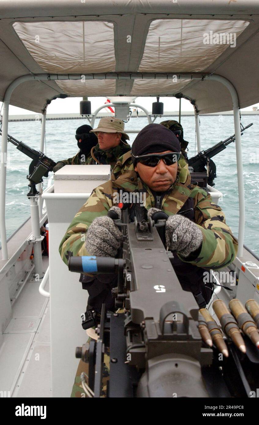 US Navy Crewmembers aboard a patrol craft assigned to Coast Guard Port ...