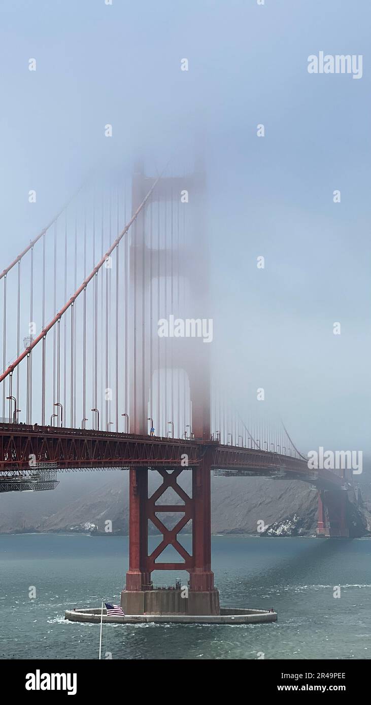 An aerial view of the iconic Golden Gate Bridge shrouded in a dense fog ...