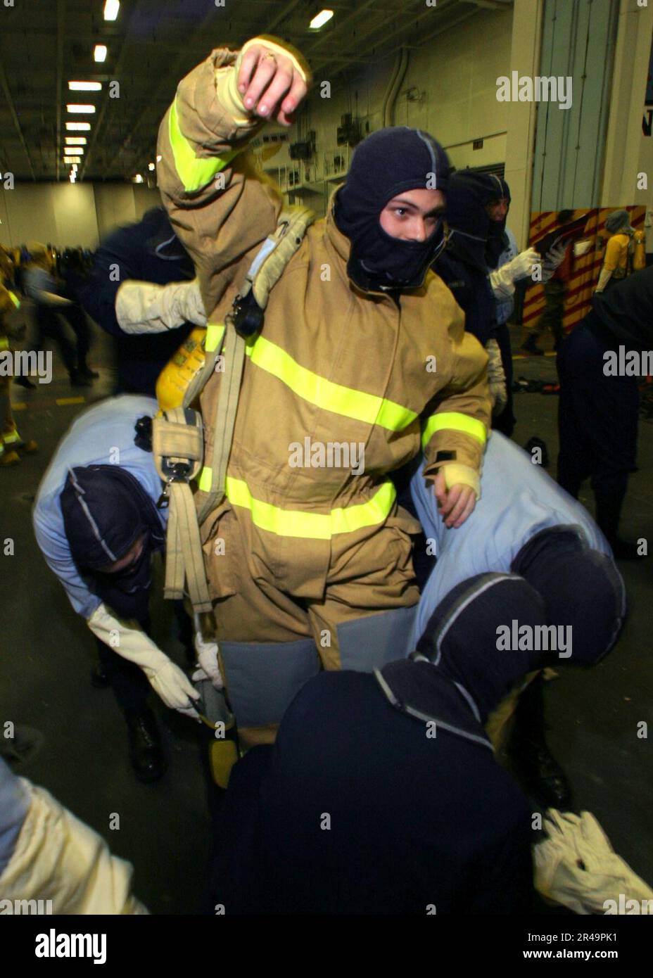 US Navy Sailors assigned to Repair Locker One Fox dress out in fire ...