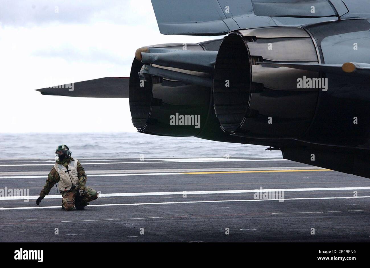 US Navy A squadron final checker gets into position to clear an F-14B ...