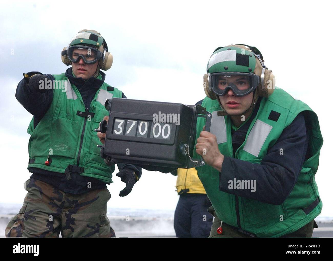 US Navy Sailors show the flight deck handlers the weight of an aircraft ...