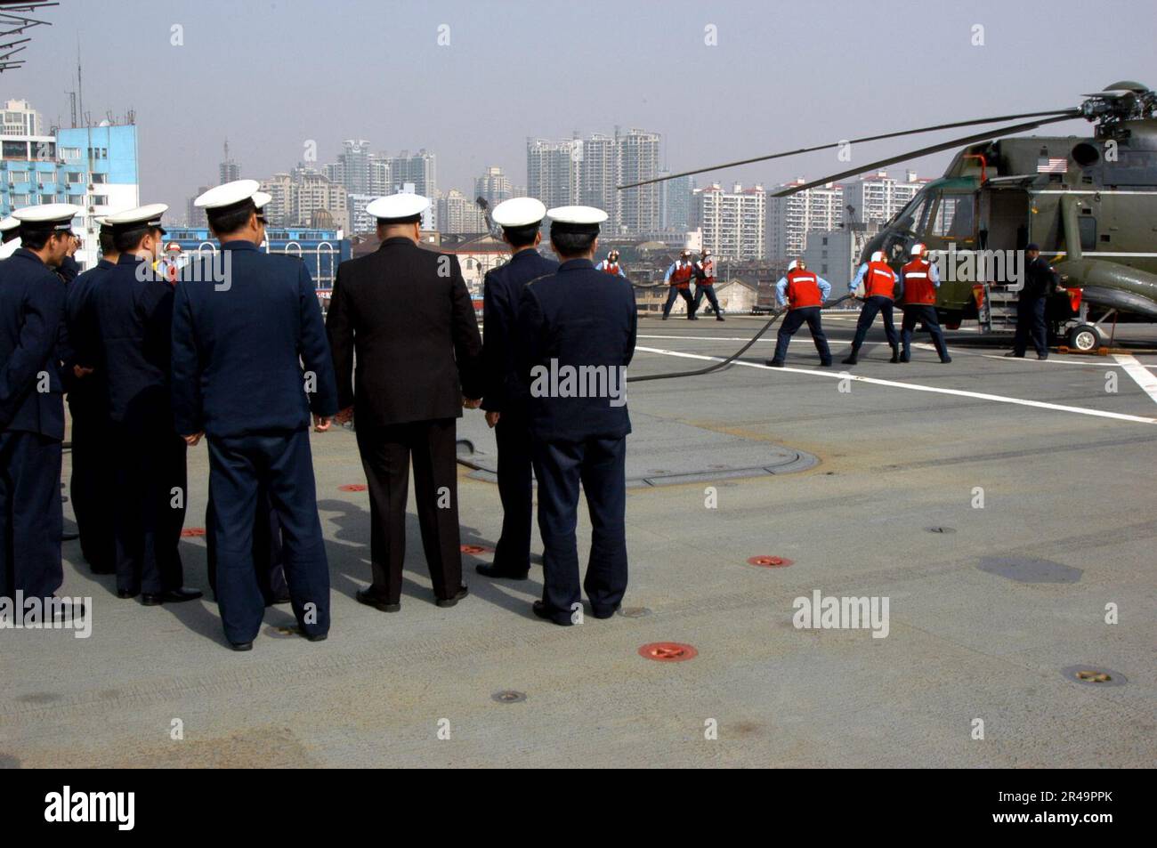 US Navy People's Liberation Army (Navy) personnel watch a crash-and ...