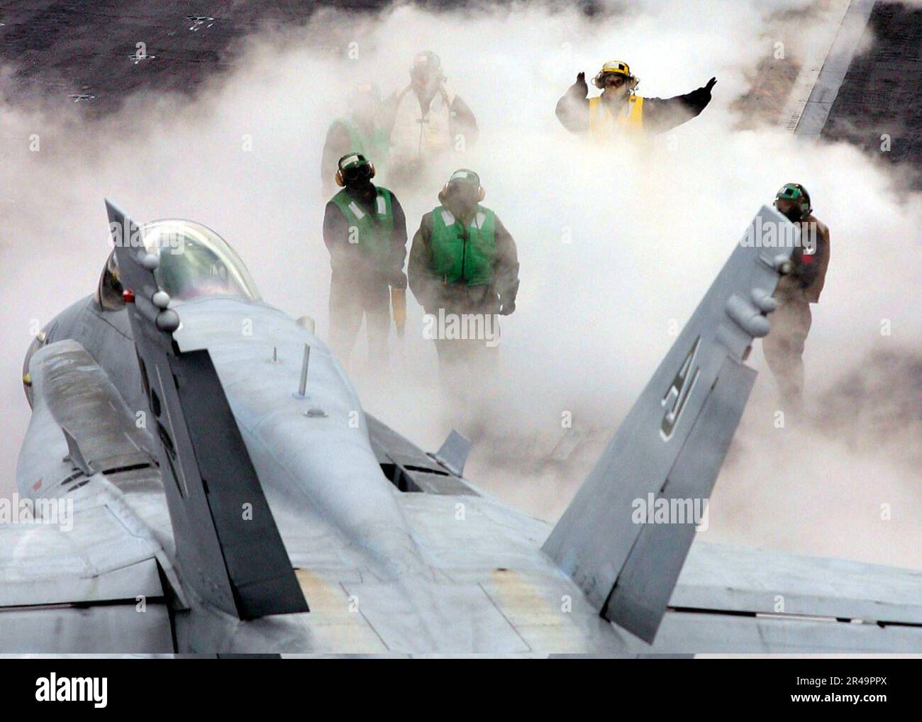 US Navy Steam rises from one of four catapult systems aboard USS Harry ...