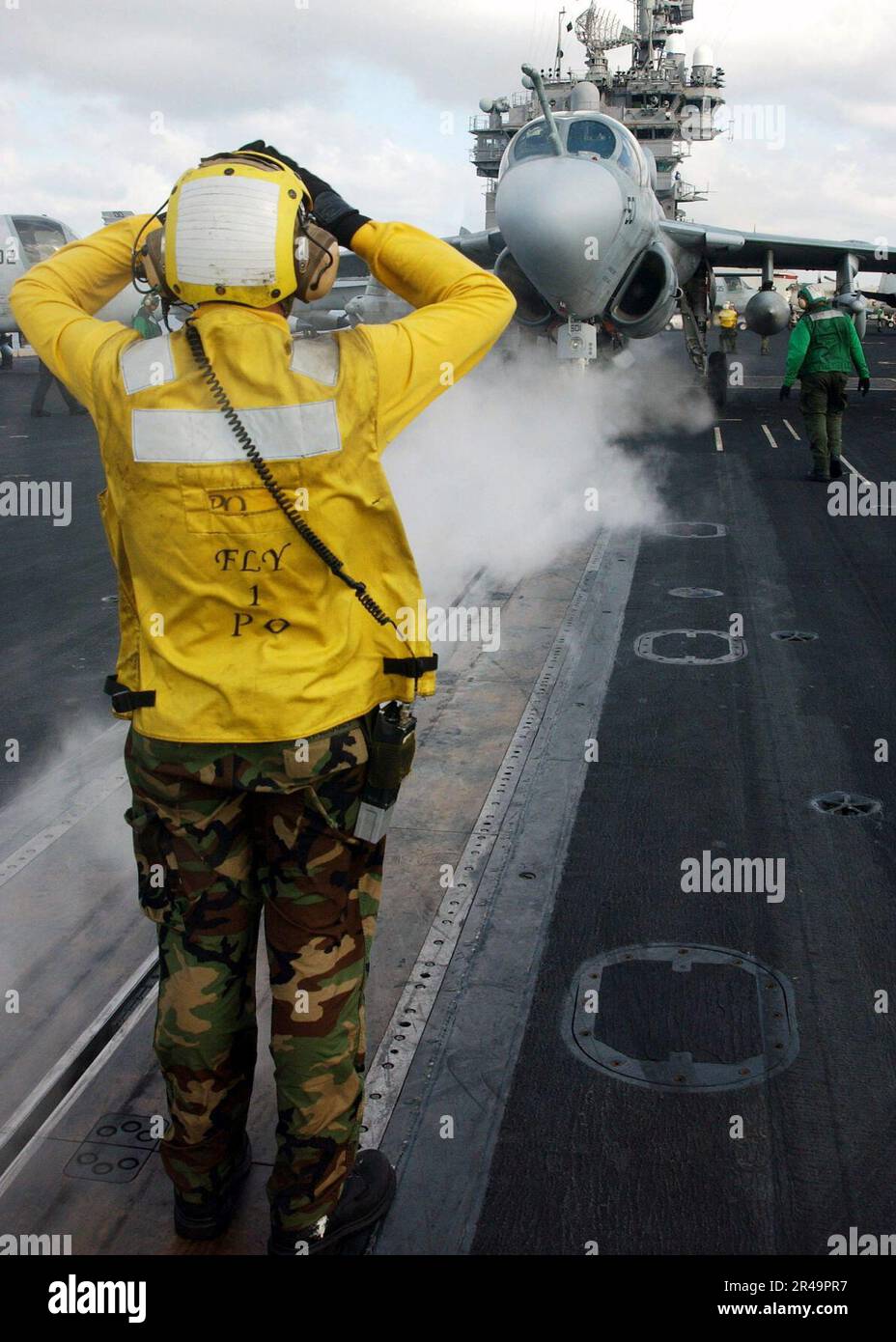 US Navy An aircraft director signals to an EA-6B Prowler assigned to ...