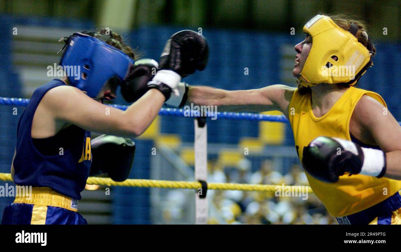 US Navy Midshipman 1st Class right, lands a stiff punch to the head of ...