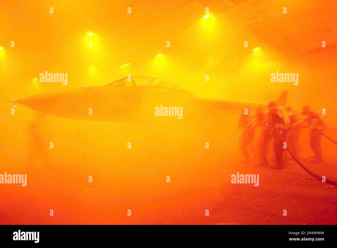 US Navy A fire party hose team practices their firefighting skills in ...