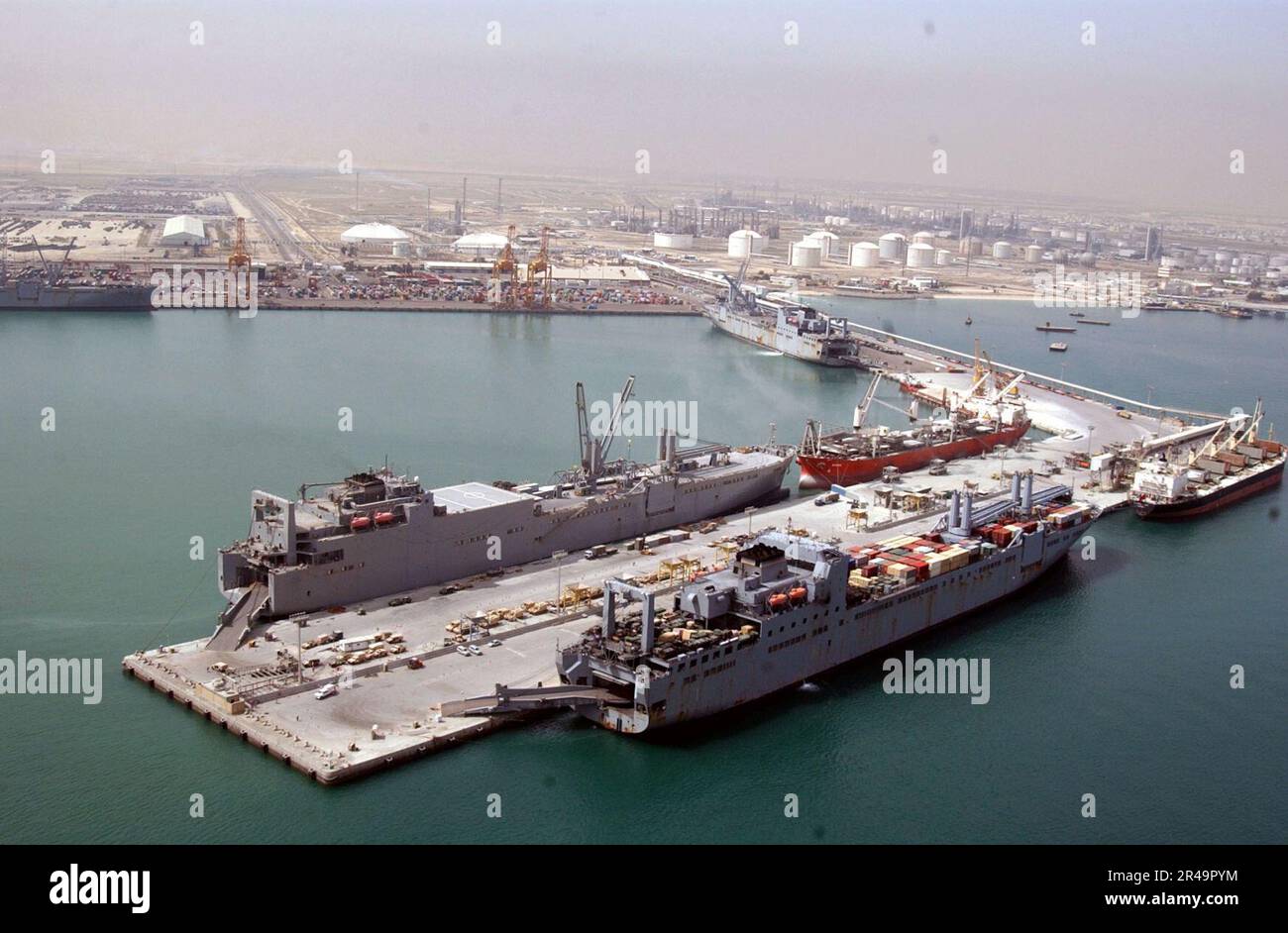 US Navy Military Sealift Command (MSC) ships sit tied up to the pier in ...