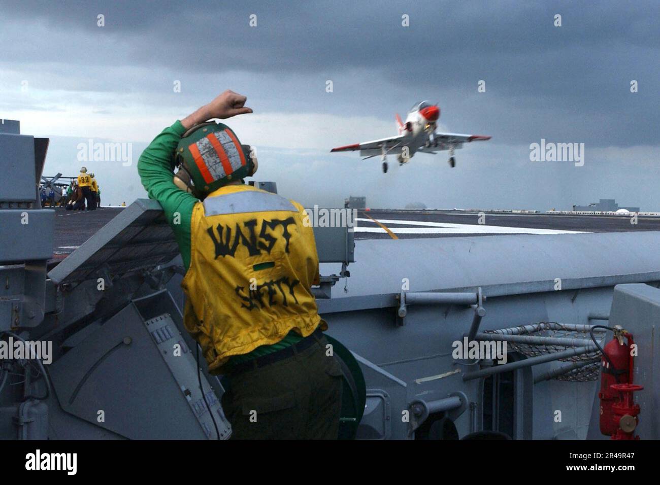 US Navy A sailor stands the waist safety watch on the ship's flight ...