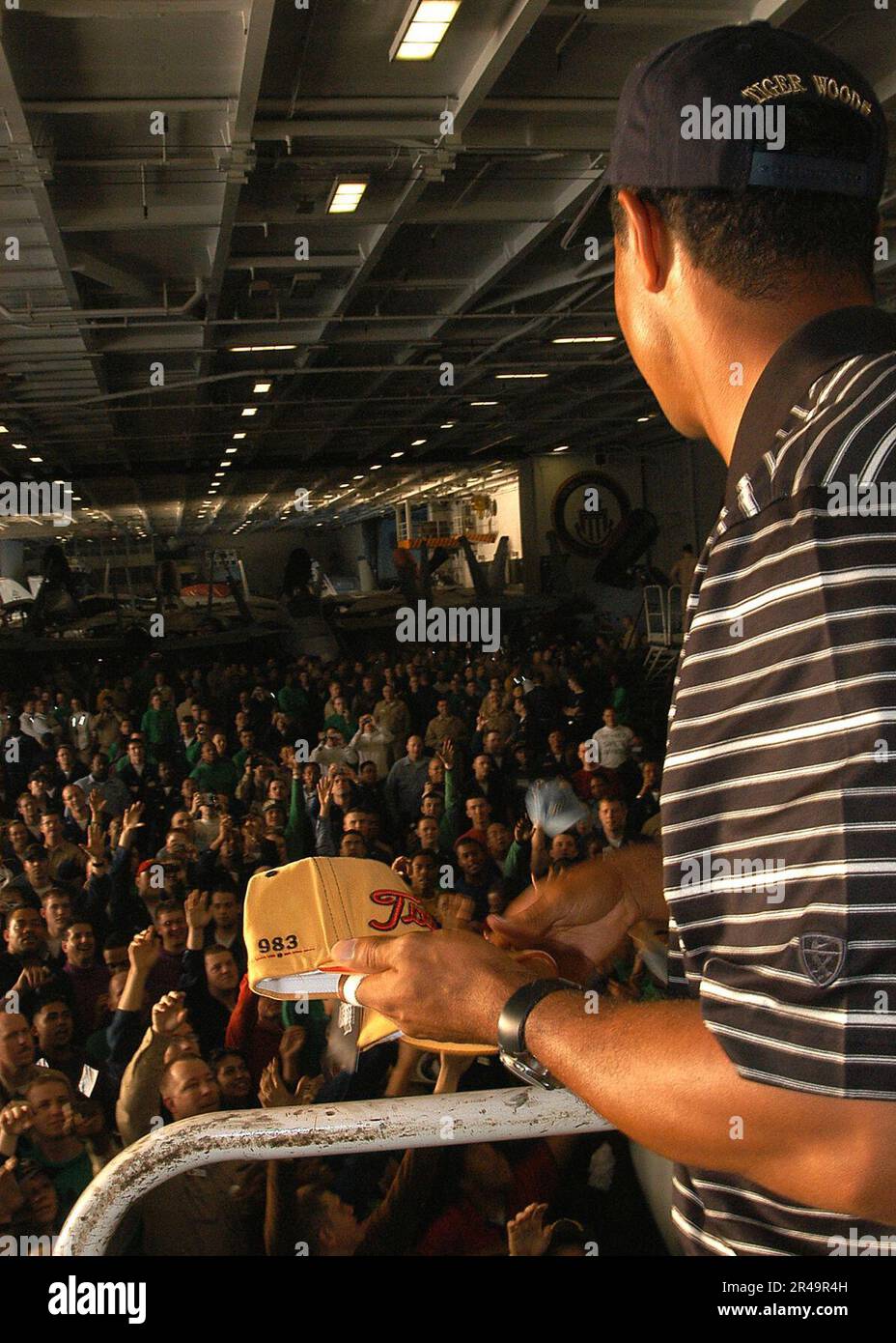 US Navy Professional golfer Tiger Woods tosses ball caps to Sailors in ...