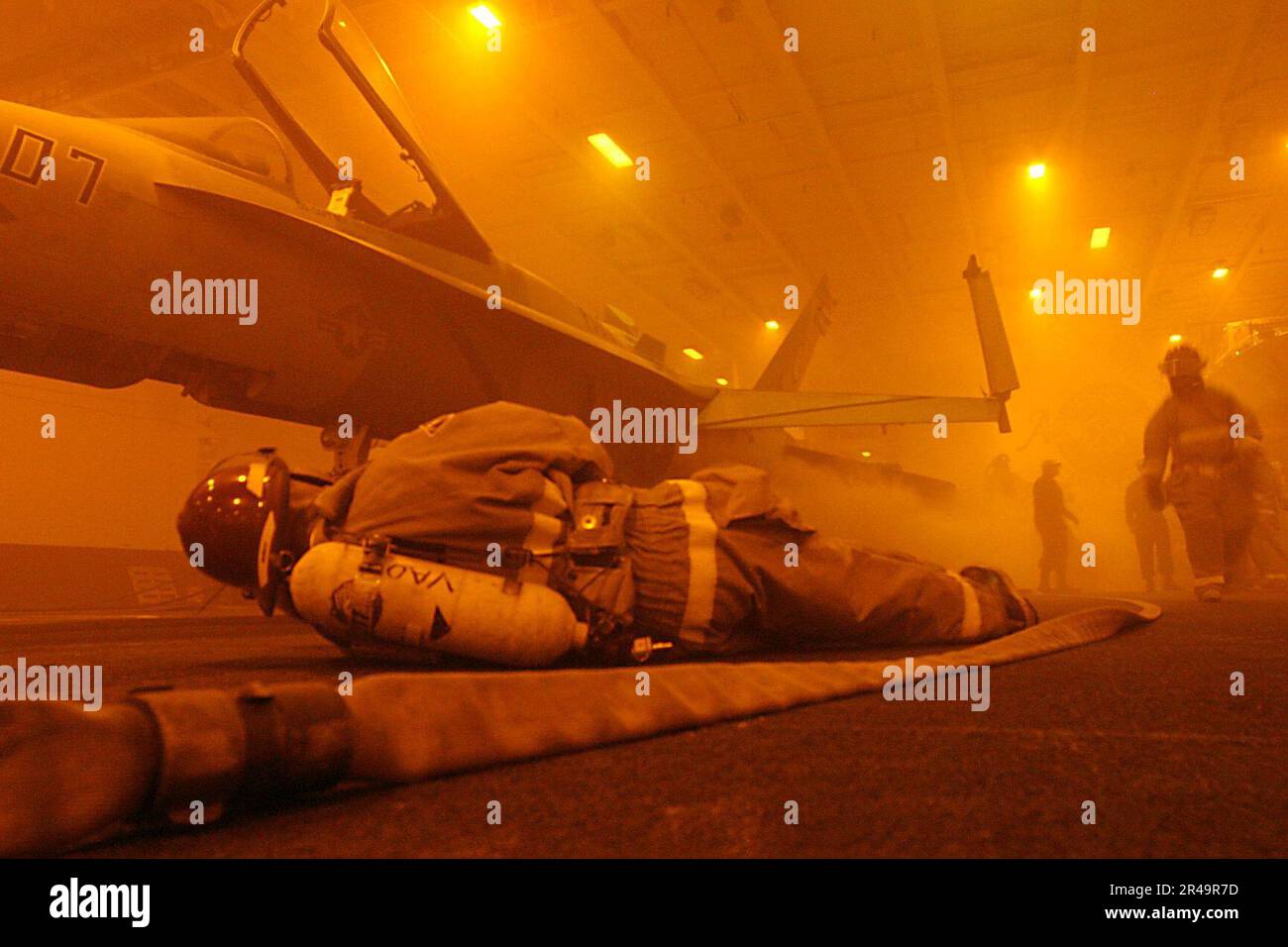 US Navy A Sailor wearing a full firefighting suite performs as a ...