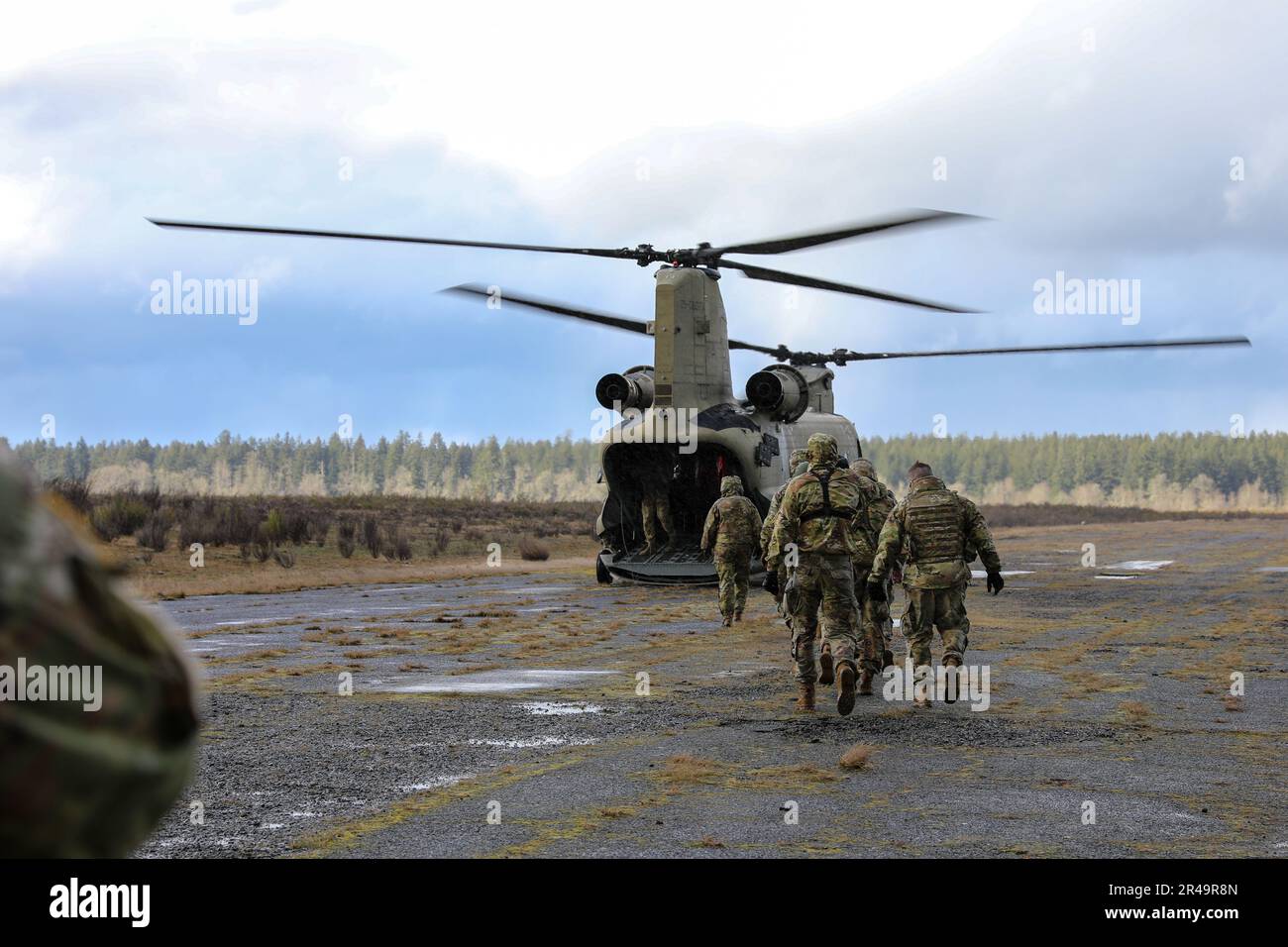 Soldiers of the 2nd Battalion, 146th Field Artillery regiment board a CH-47 Chinook helicopter ...