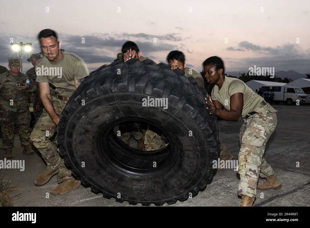 U.S. Army Soldiers flip a tire during a U.S. service competition in ...