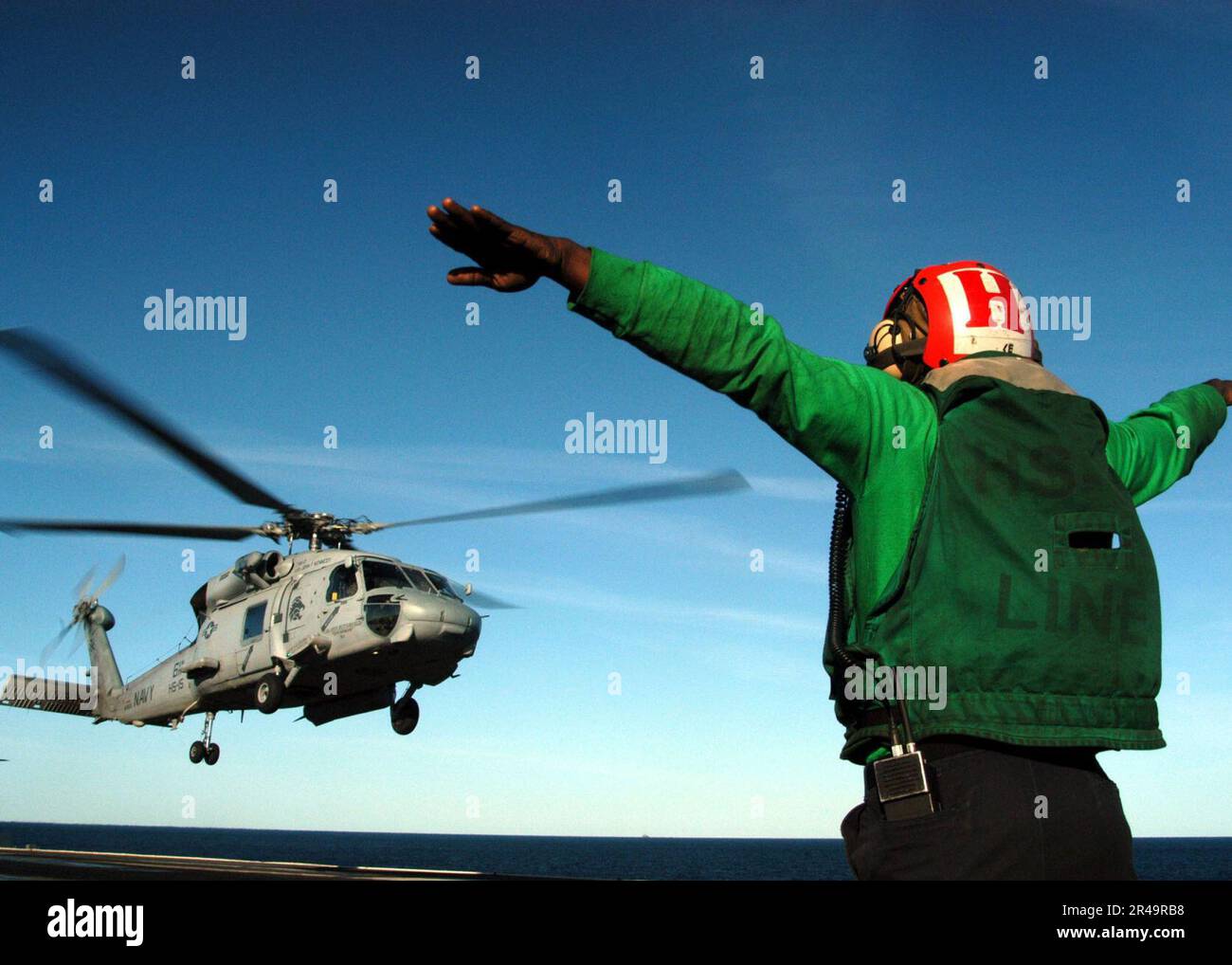 US Navy A Landing Signal Enlisted (LSE) signals an SH-60F Seahawk ...