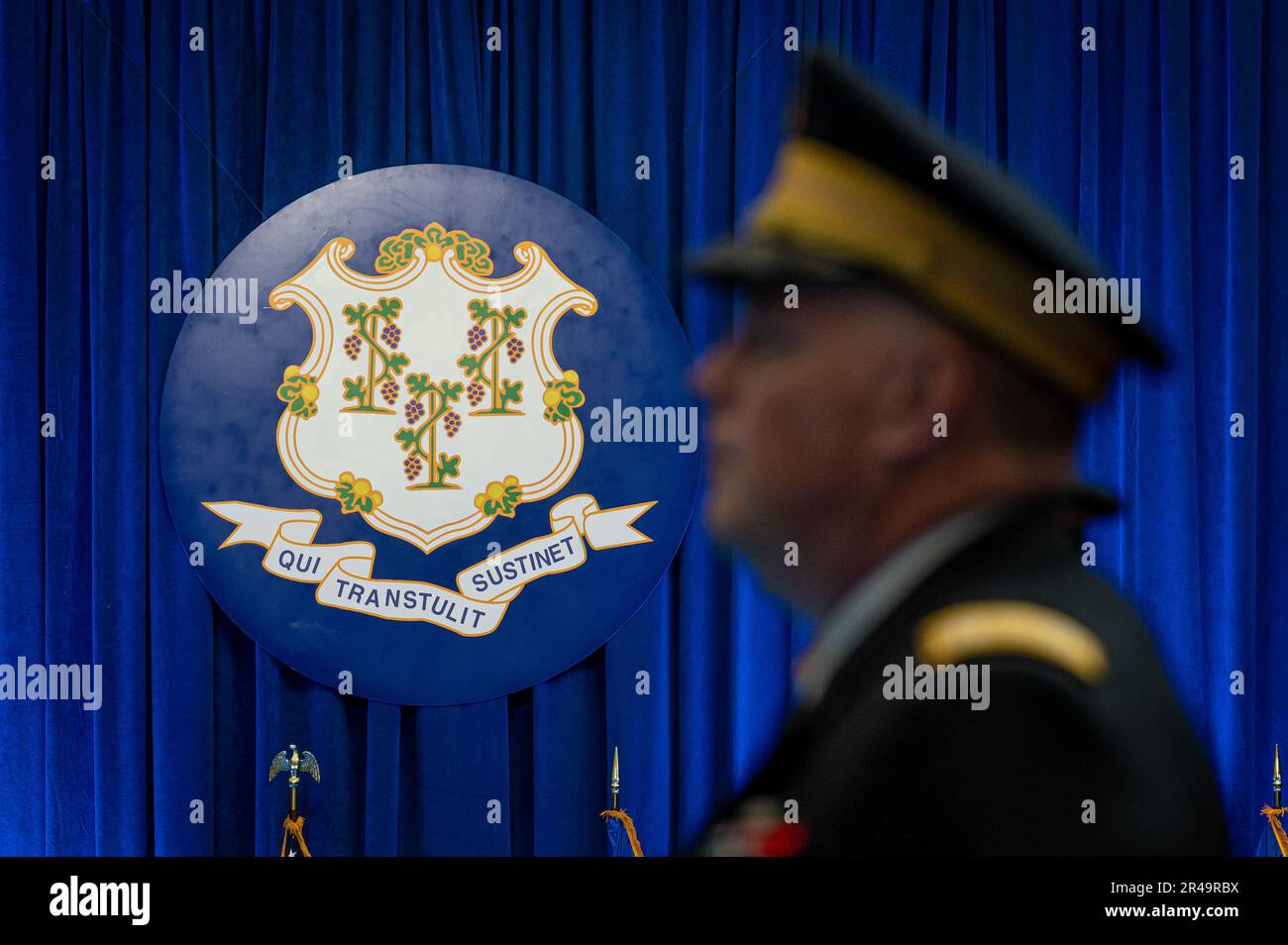 The state of Connecticut seal hangs above the stage of the state's 89th ...