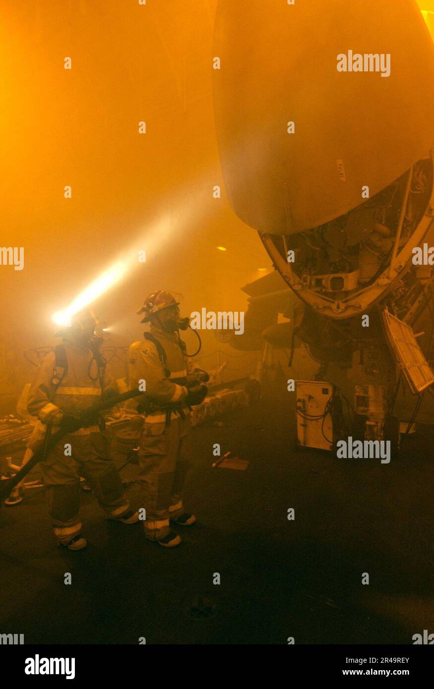 US Navy A fire fighting hose team advances on an EA-6B Prowler assigned ...
