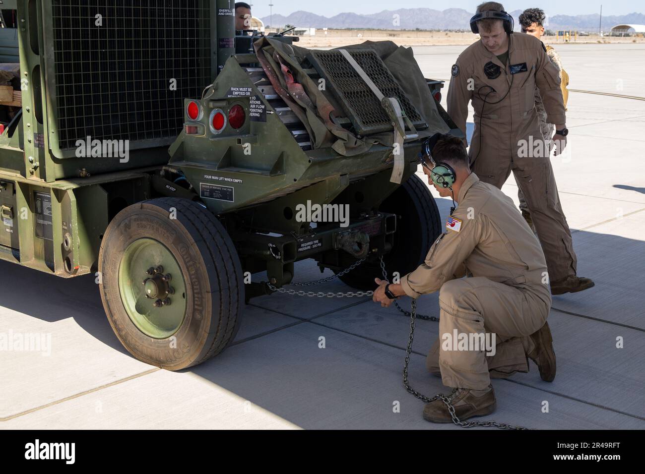 U.S. Marine Corps Cpl. Tyler Hatto, bottom, a crew chief assigned to ...