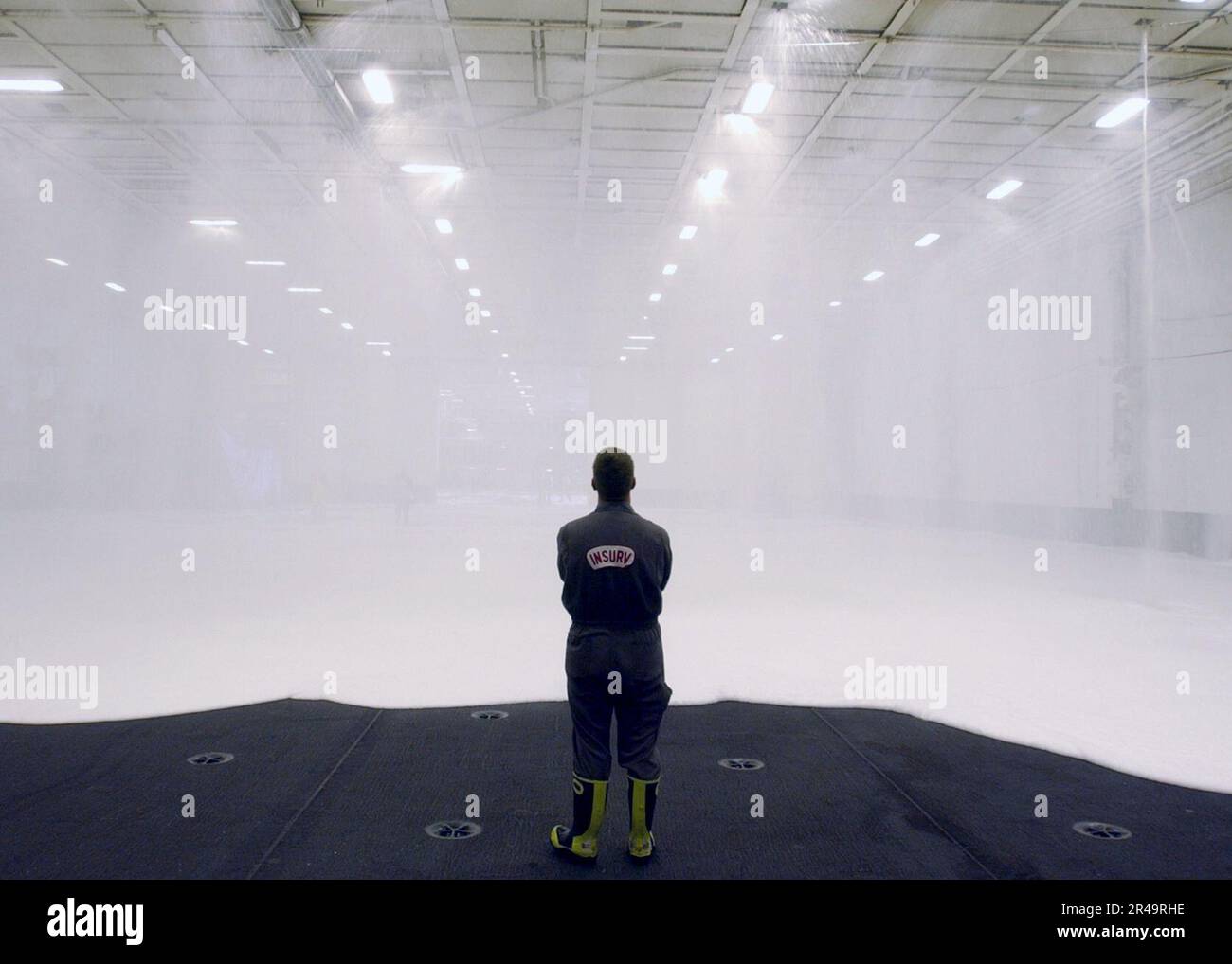US Navy Lt. Cdr. observes the Aqueous Film Forming Foam (AFFF ...