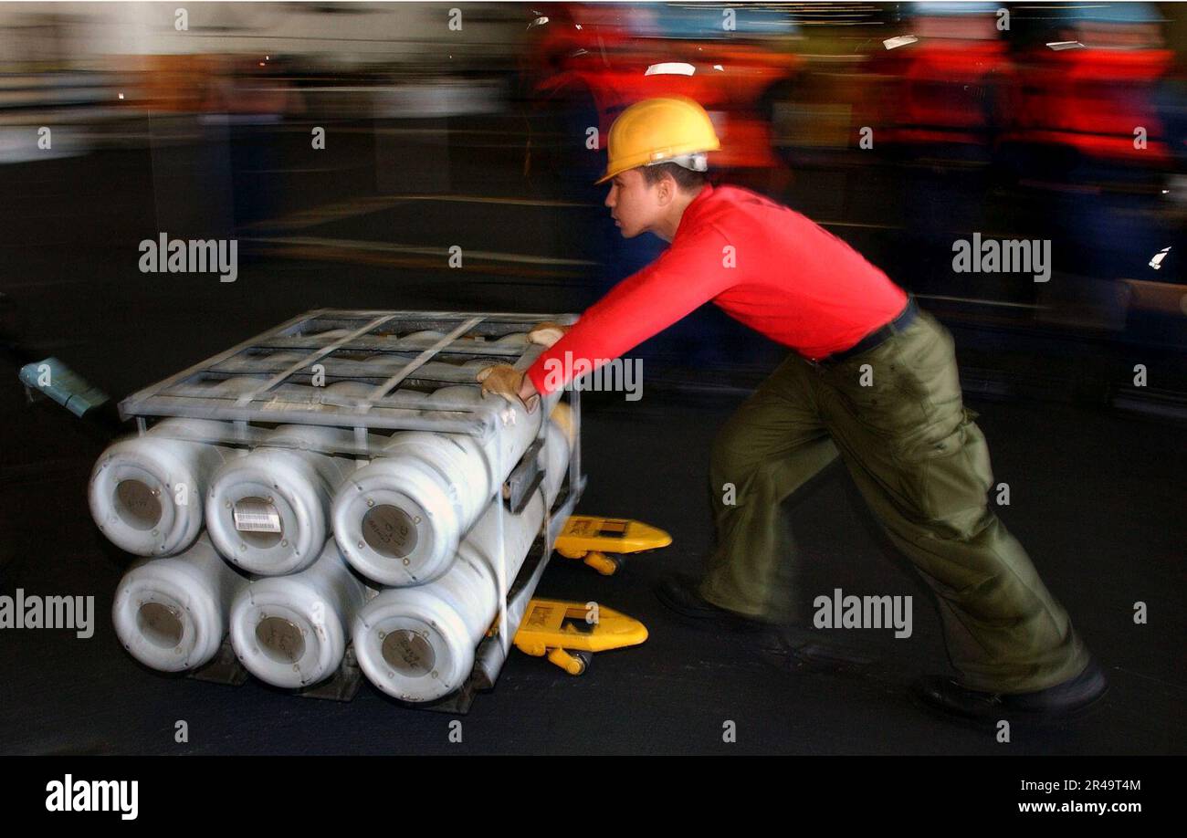 US Navy An Aviation Ordnanceman moves a pallet of BLU-111 500 lb. bombs ...