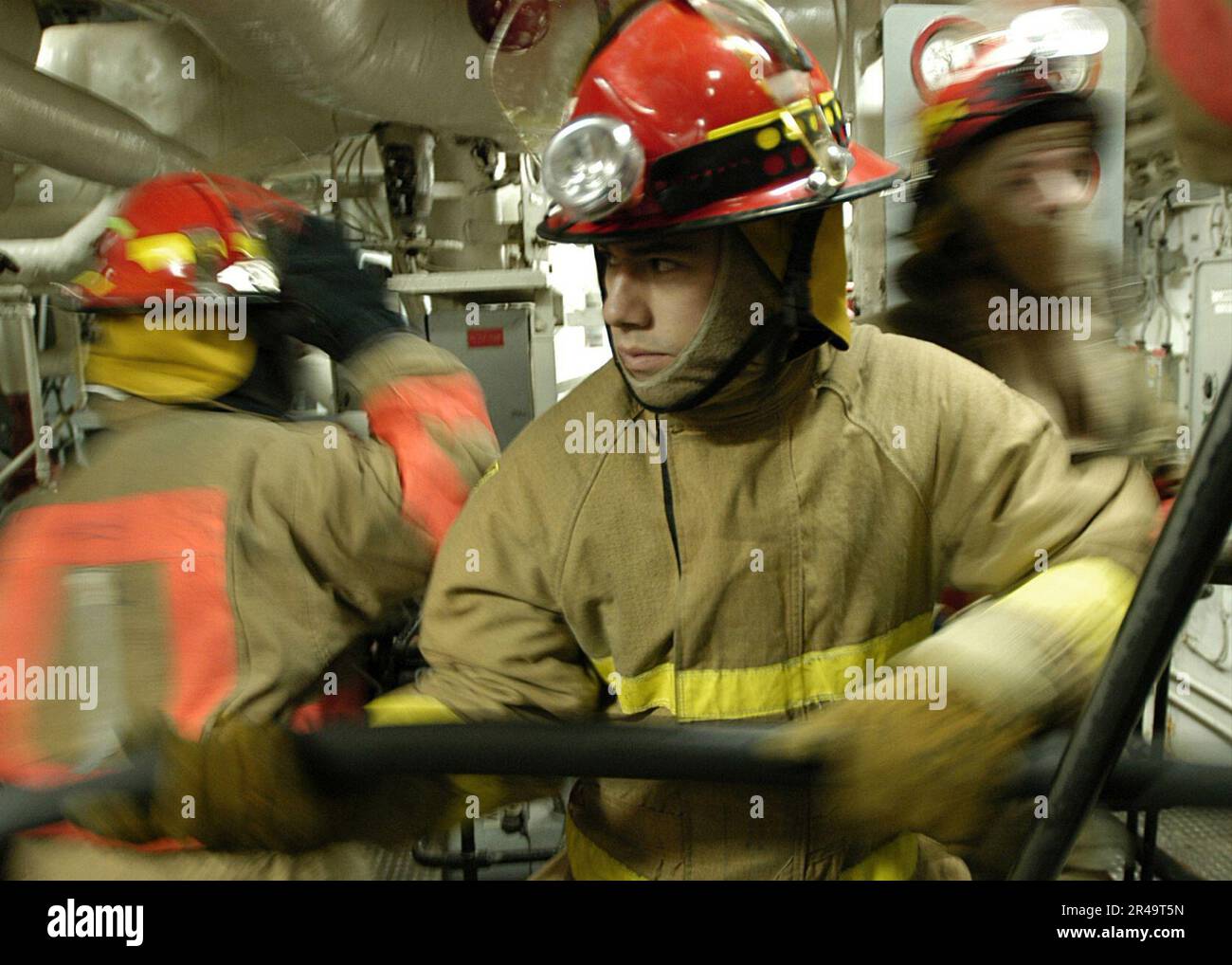 US Navy Aviation Structural Mechanic relieves another sailor as hoseman ...