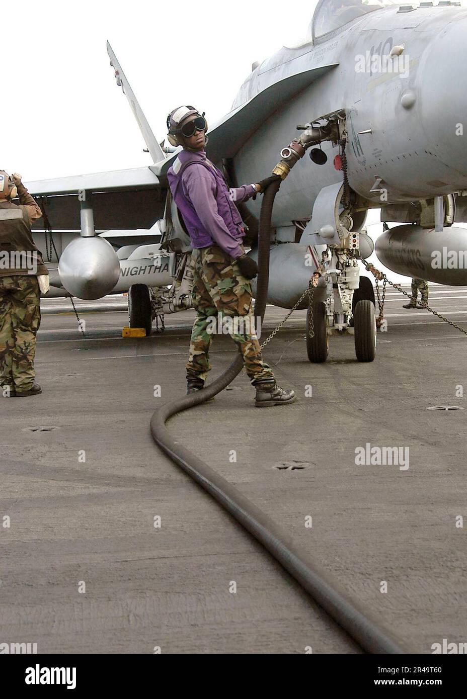 US Navy Aviation Boatswain's Mate fuels an F-A-18C Hornet assigned to ...
