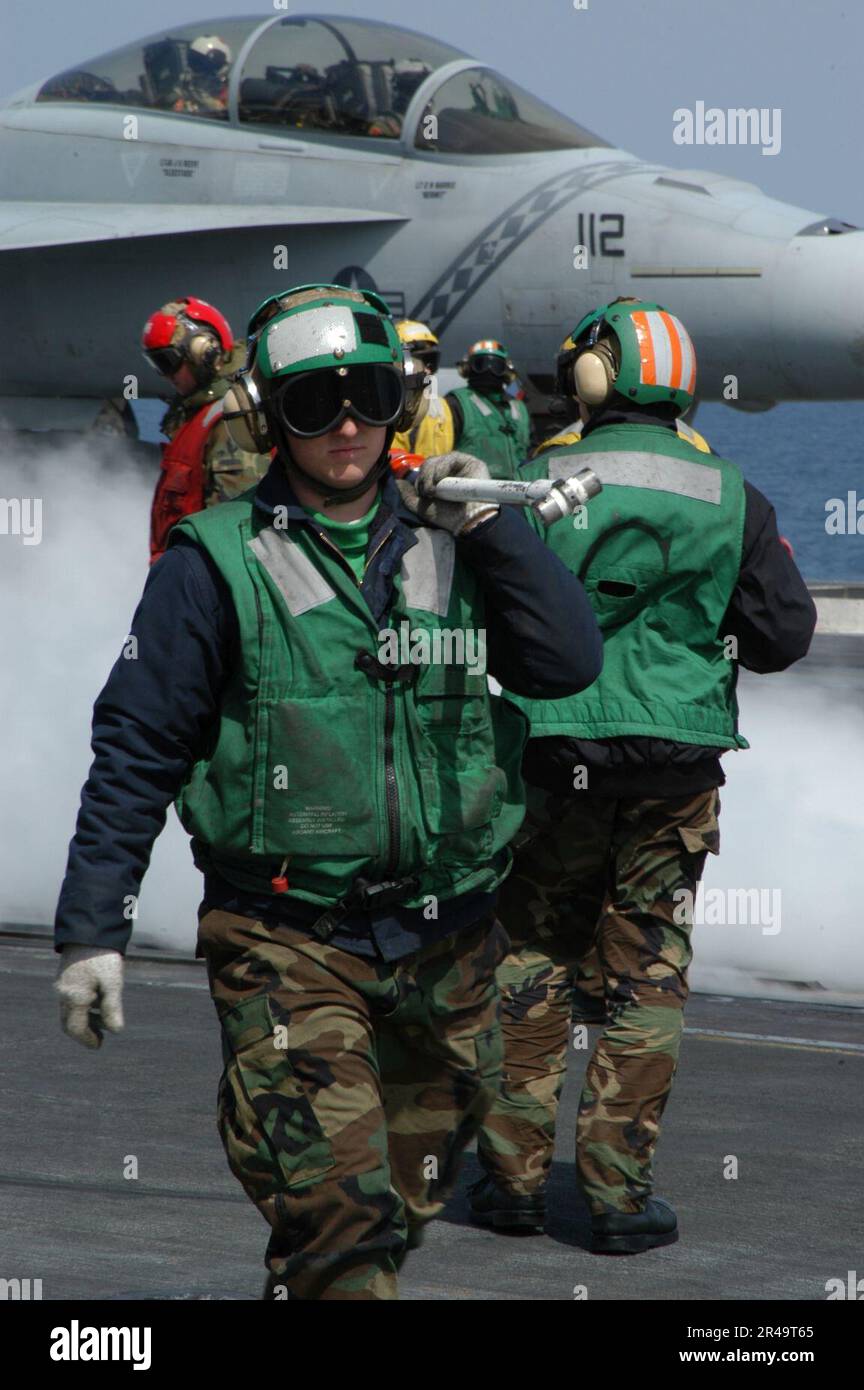 US Navy Aviation Boatswain's Mate clears one of four catapults on the ...