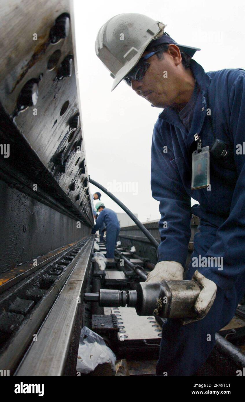 US Navy Civilian ship fitter Philippines, drills in catapult alignments aboard the nuclear ...